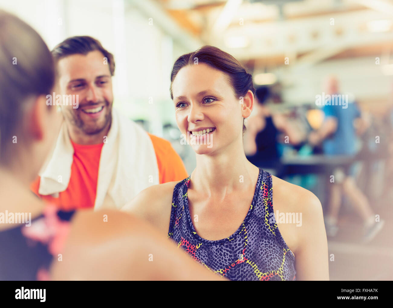 Smiling friends talking in gym Stock Photo - Alamy
