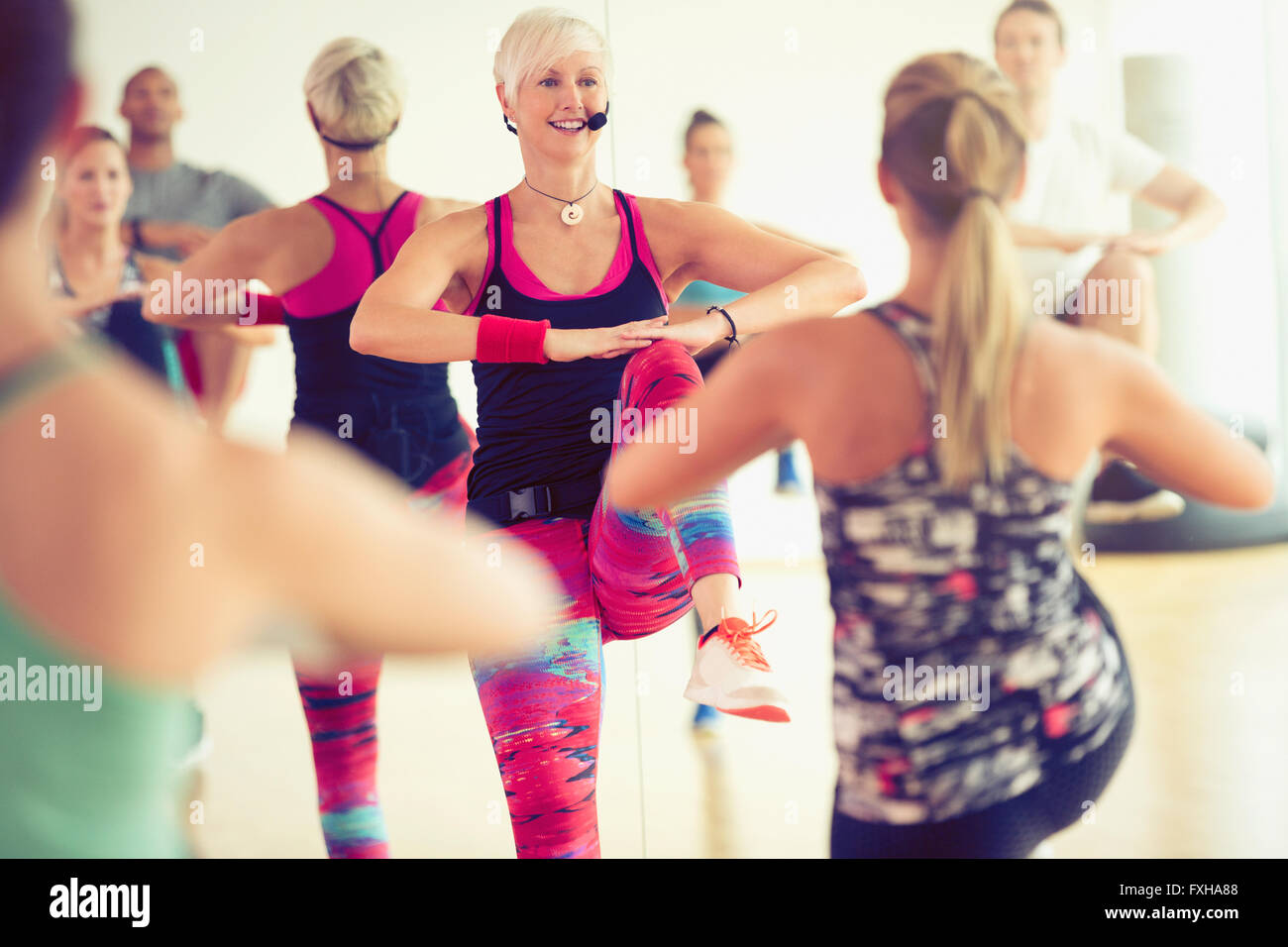 Fitness instructor leading aerobics class Stock Photo - Alamy