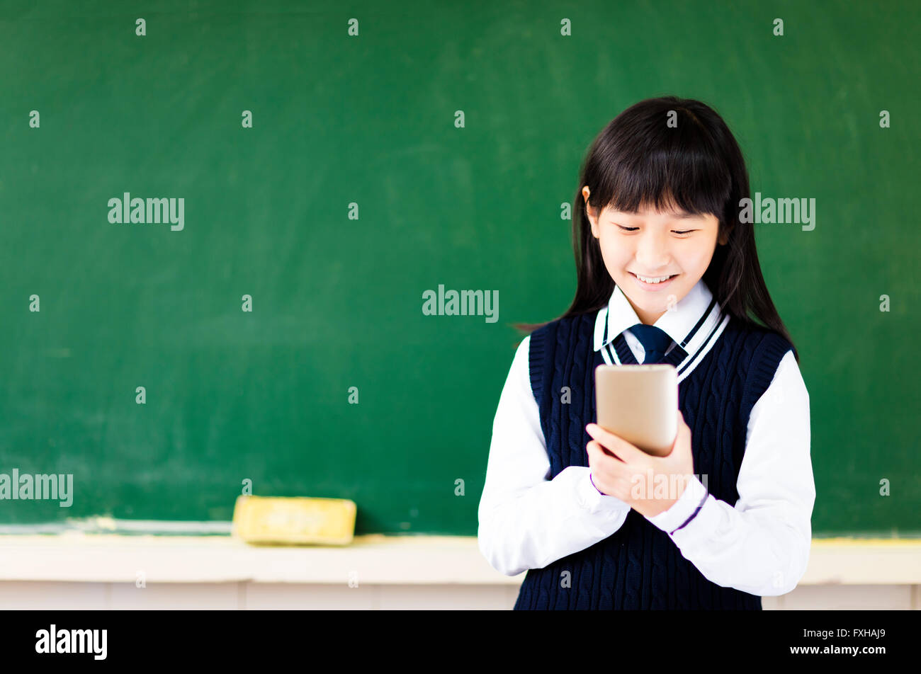 happy student girl with smart phone in classroom Stock Photo - Alamy