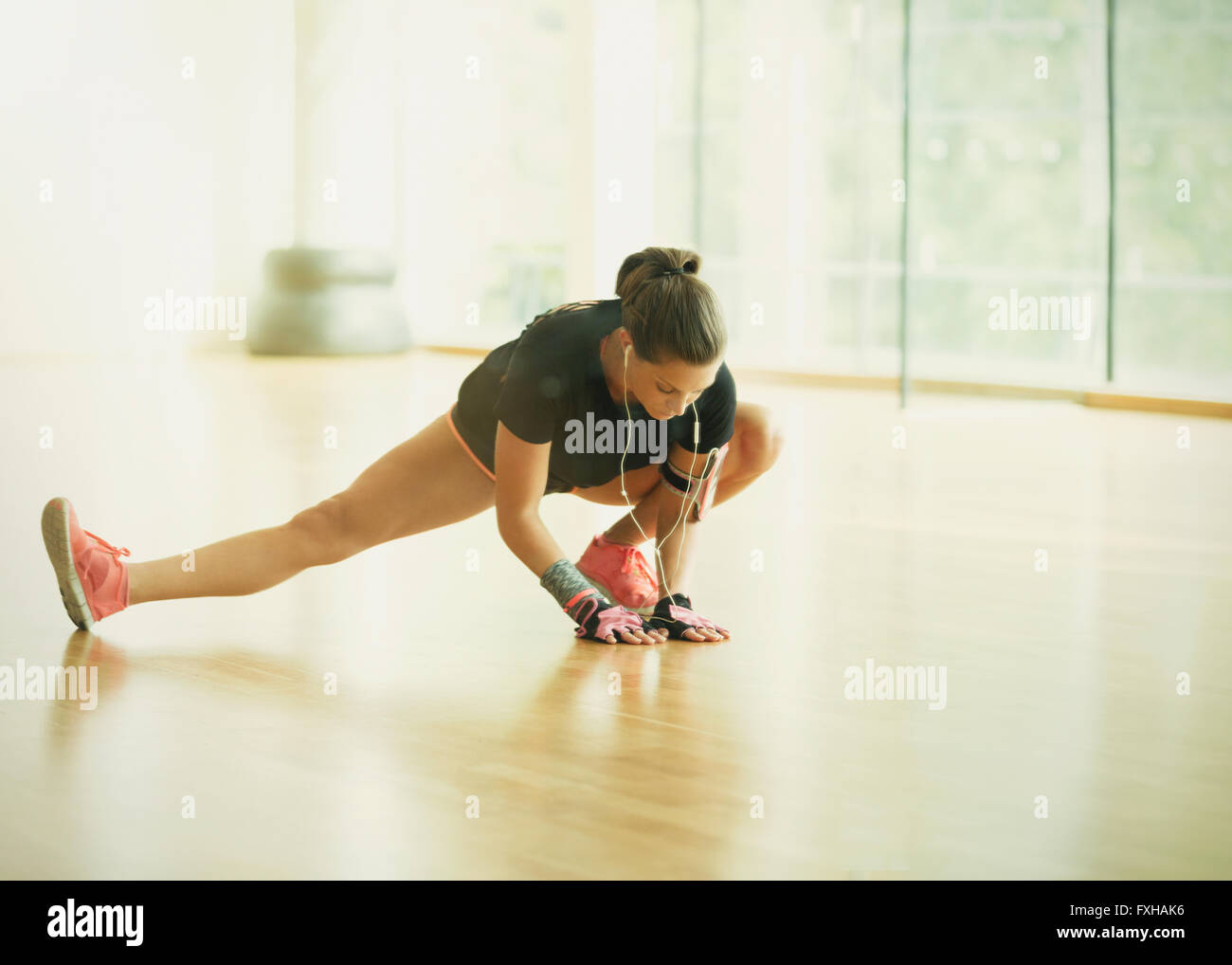 Woman stretching leg in gym studio Stock Photo - Alamy