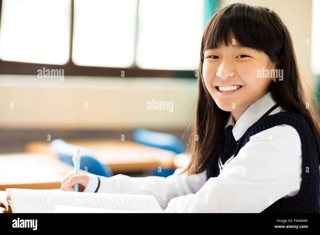 happy pretty student girl with books in classroom Stock Photo - Alamy