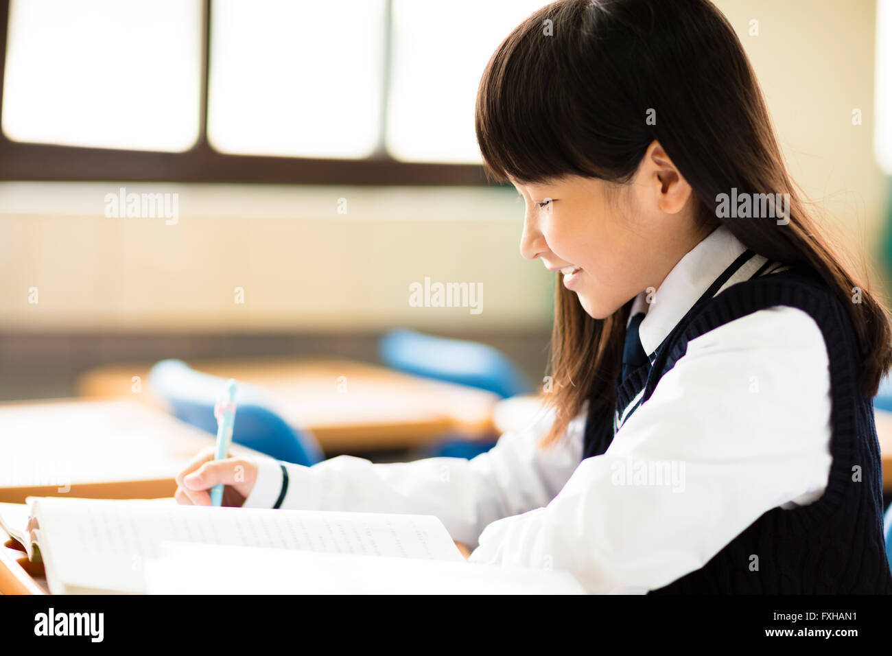 happy pretty student girl with books in classroom Stock Photo - Alamy