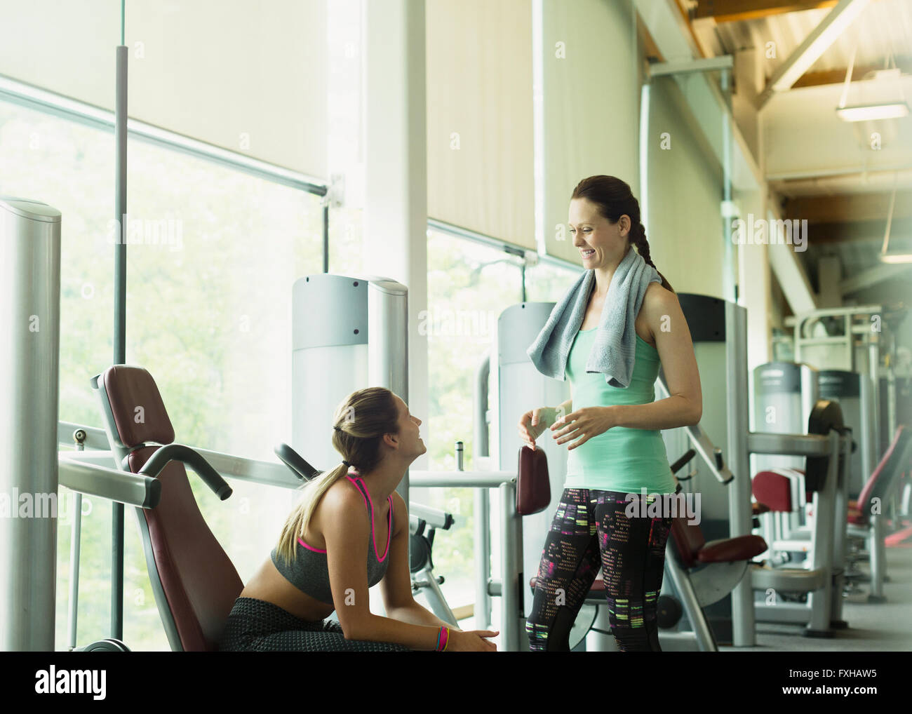 Women talking and resting at gym Stock Photo - Alamy