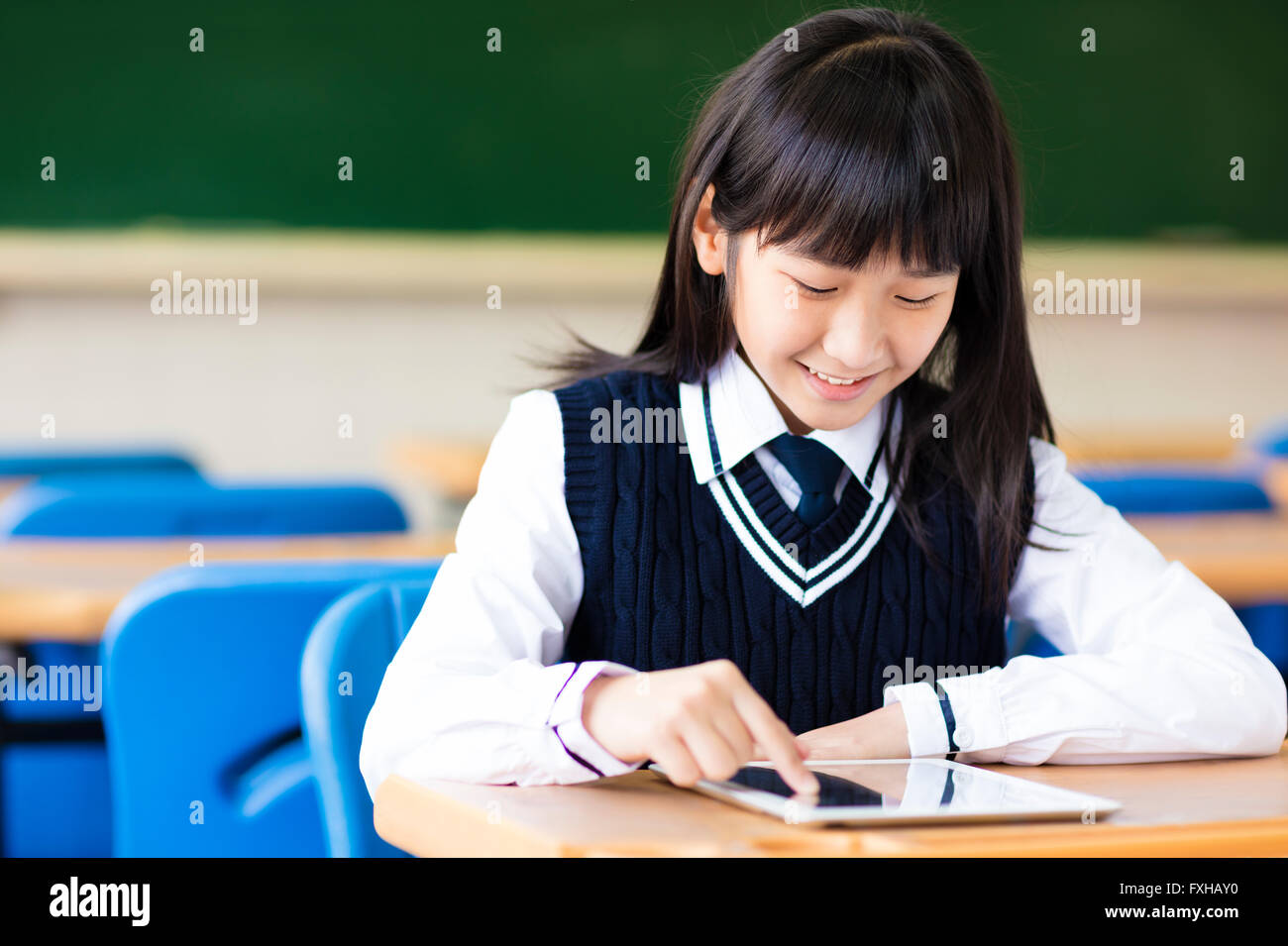 happy pretty student girl with tablet in classroom Stock Photo - Alamy