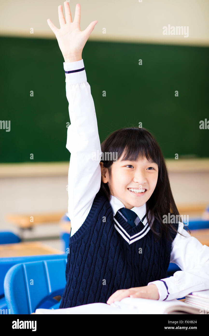 pretty student girl raising hand in classroom Stock Photo - Alamy