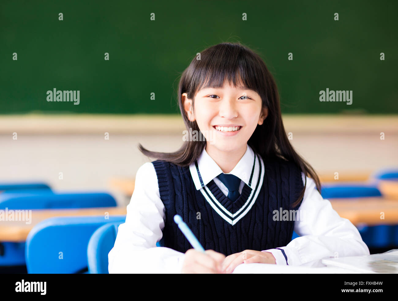 happy pretty student girl with books in classroom Stock Photo - Alamy