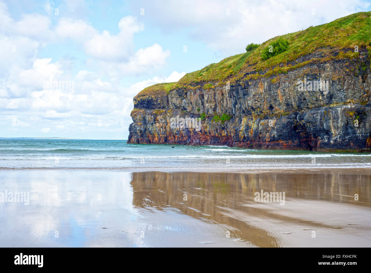 lone kayaker near the cliffs of ballybunion beach on the wild atlantic ...