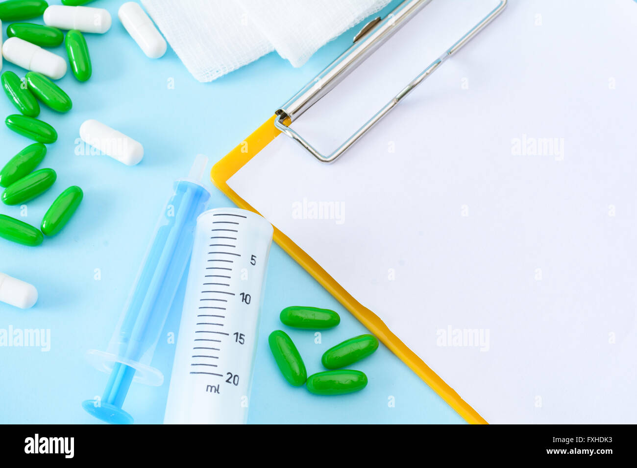 Medical conceptual picture with pills, injection, empty clipboard sheet ...