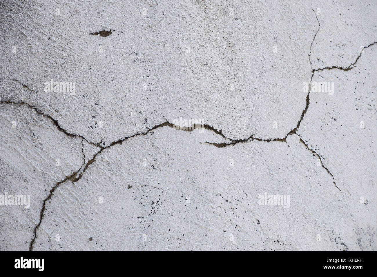 Damage split crack in white painted plaster concrete wall background ...