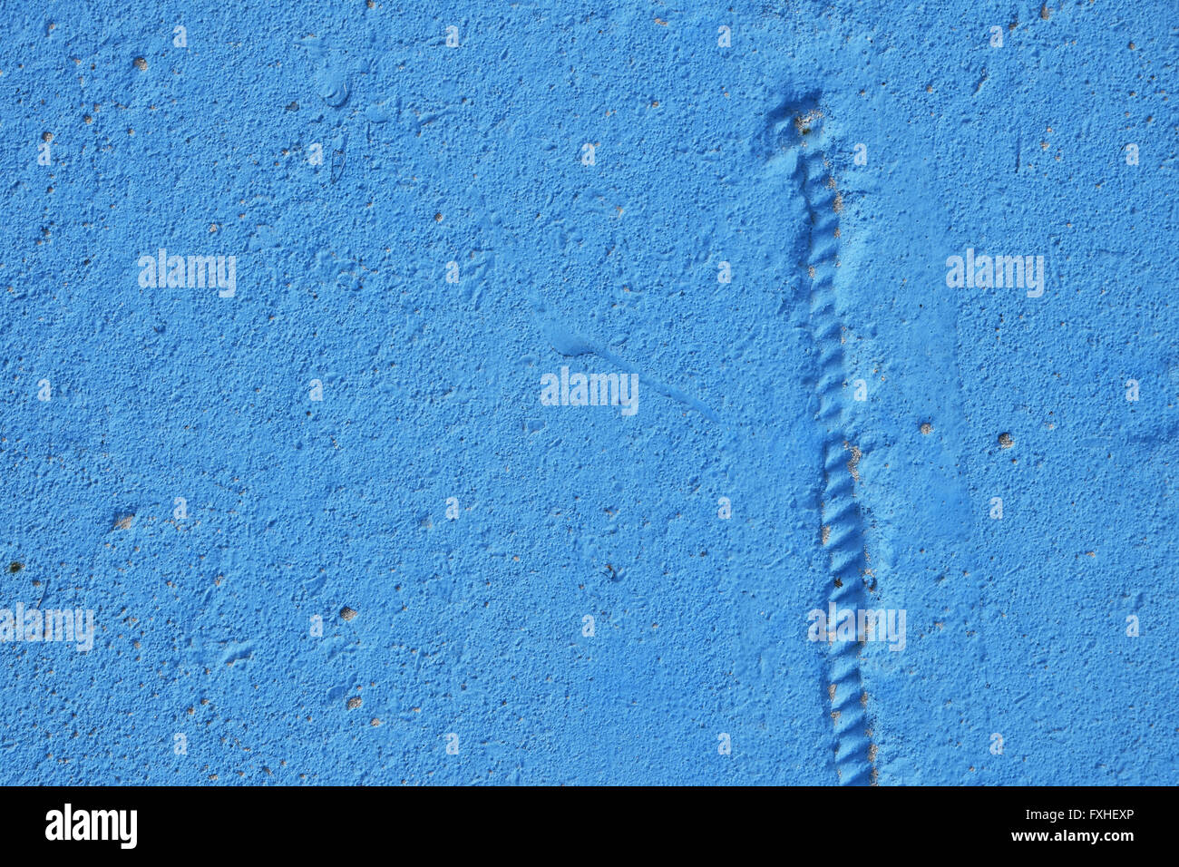 Blue painted concrete wall or floor with paint runs, sagging and ...