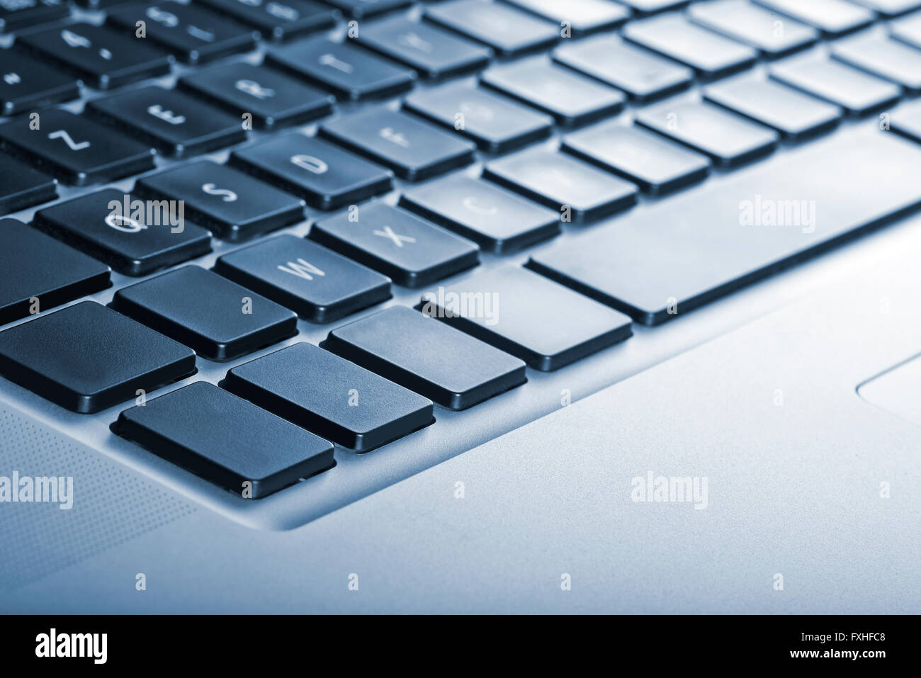 Keyboard from laptop with cyanotype saturation and fine shallow of ...