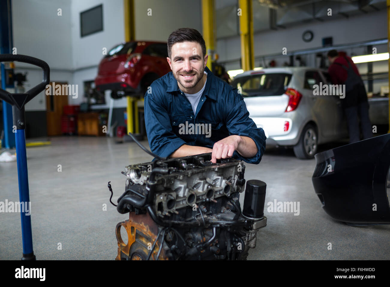 Mechanic working on an engine Stock Photo - Alamy