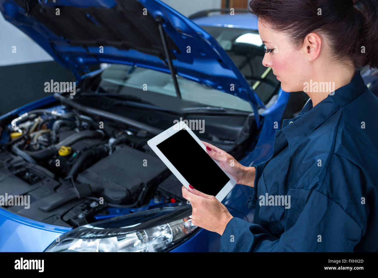 Female mechanic with digital tablet Stock Photo - Alamy
