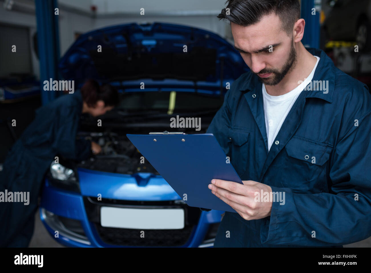 Mechanic preparing a check list Stock Photo - Alamy
