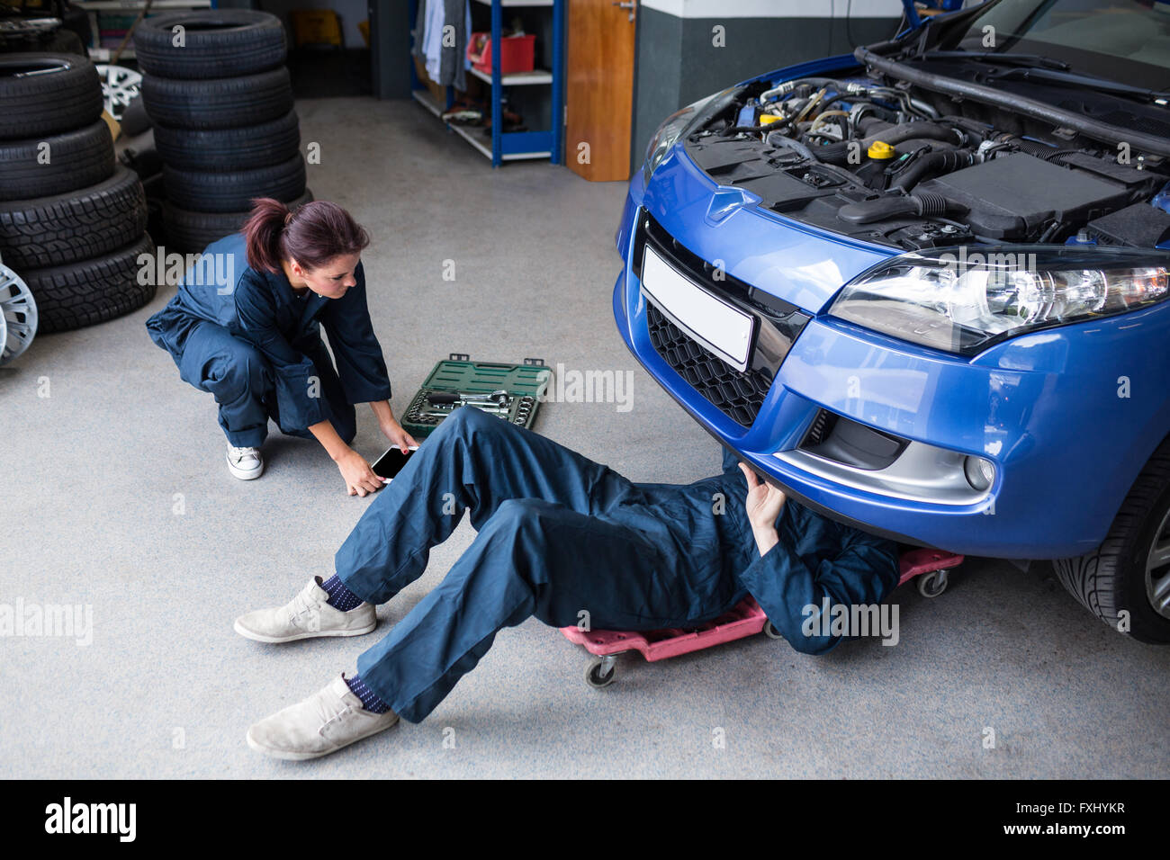 Mechanics repairing a car at the repair garage Stock Photo - Alamy