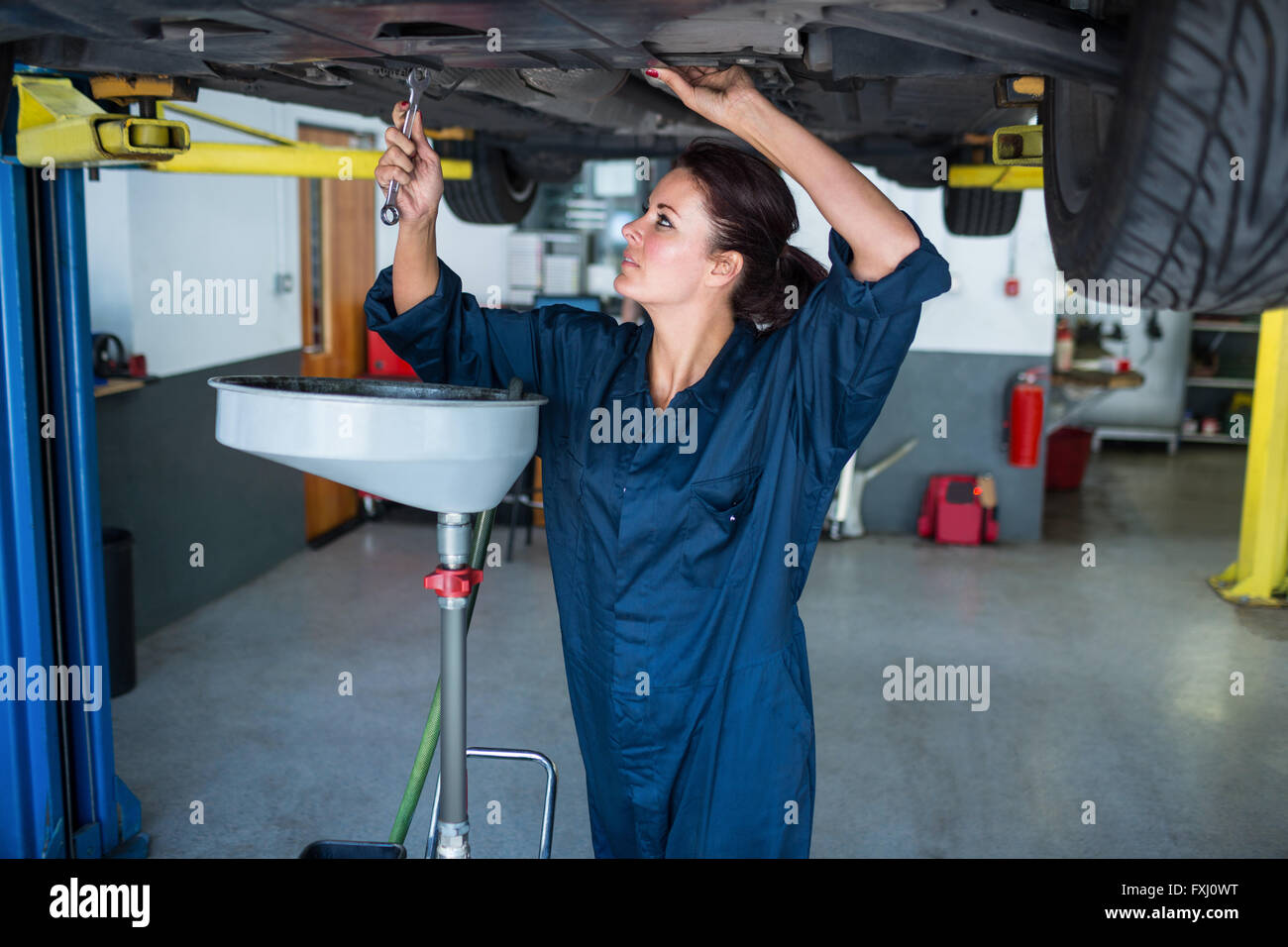 Female mechanic servicing a car Stock Photo - Alamy