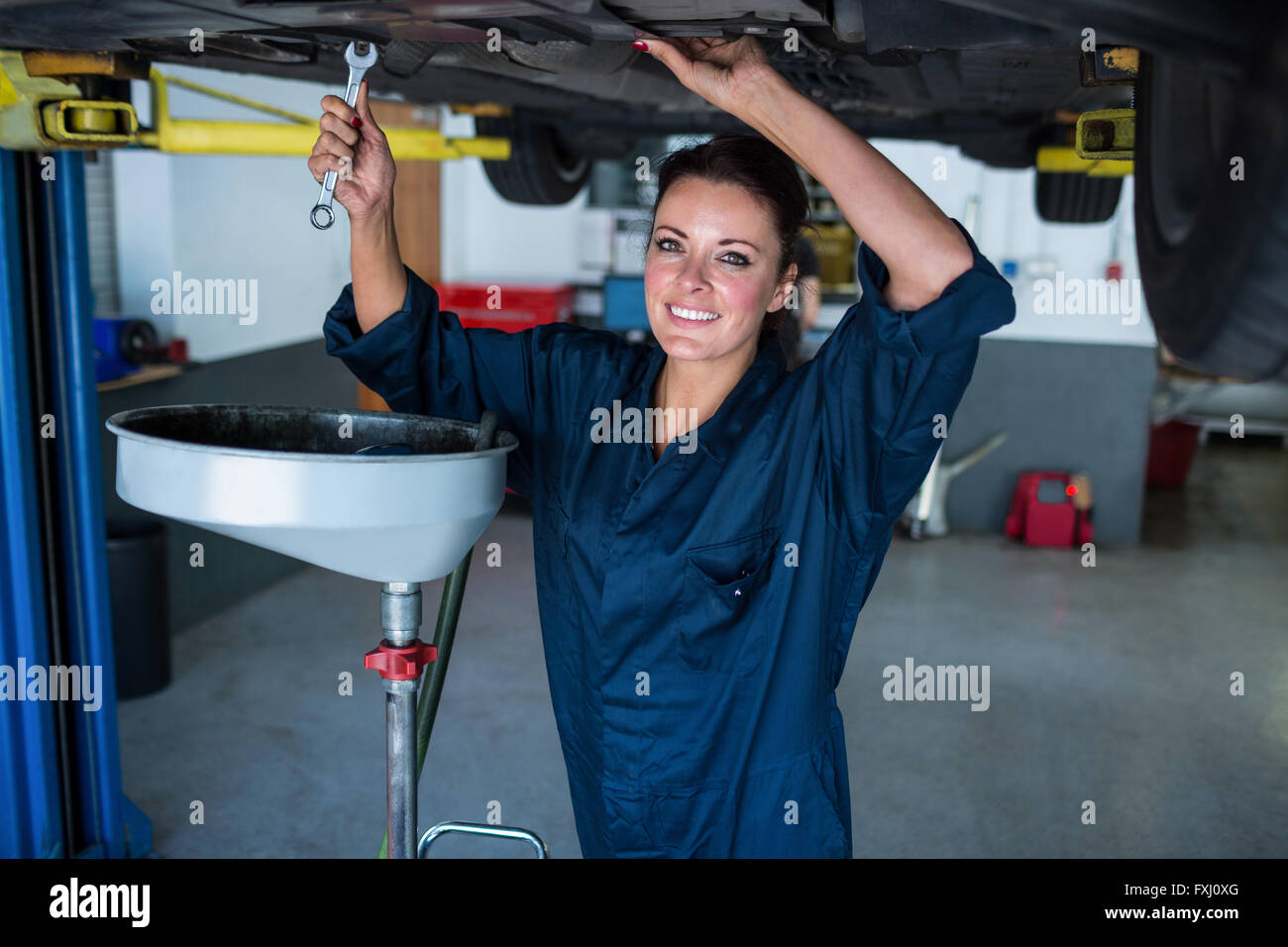 Female mechanic servicing a car Stock Photo - Alamy