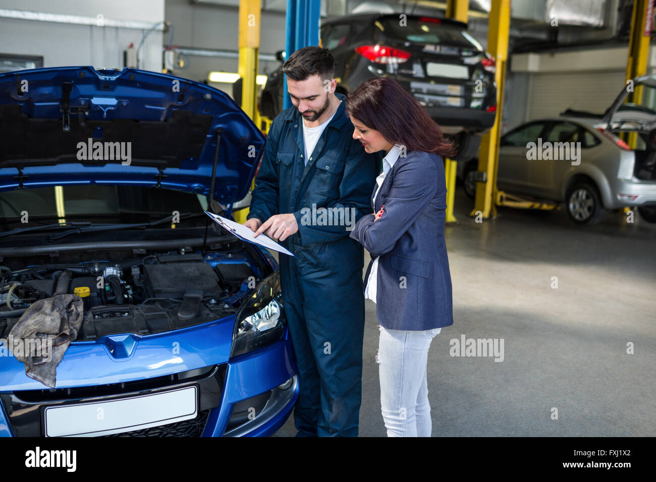 Mechanic showing quotation customer hi-res stock photography and images ...
