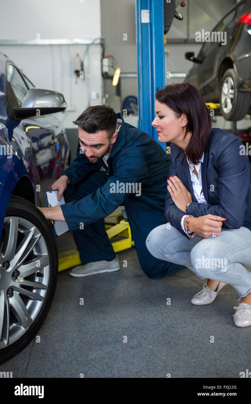 Mechanic showing customer the problem with car Stock Photo - Alamy