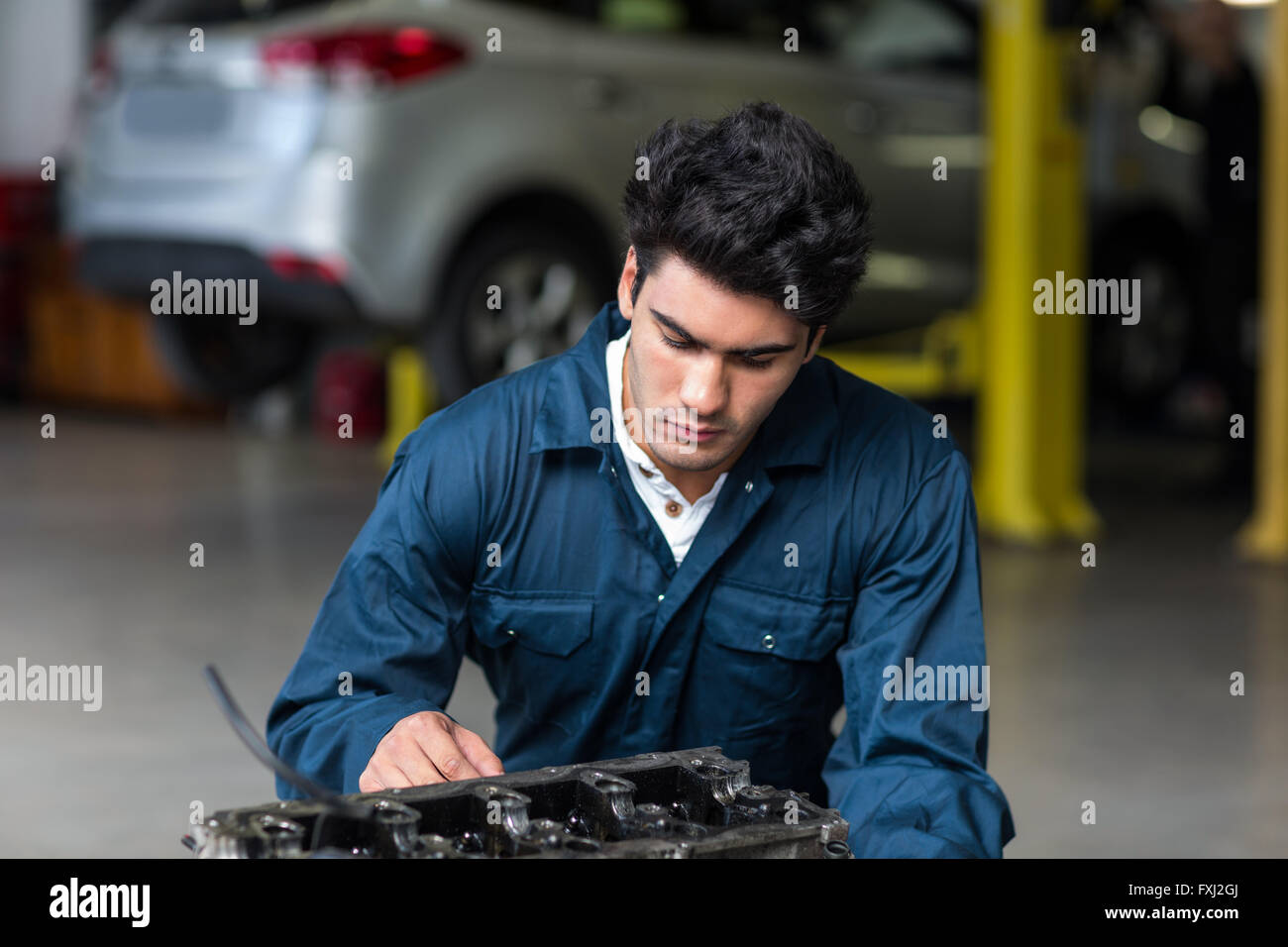 Mechanic working on an engine Stock Photo - Alamy