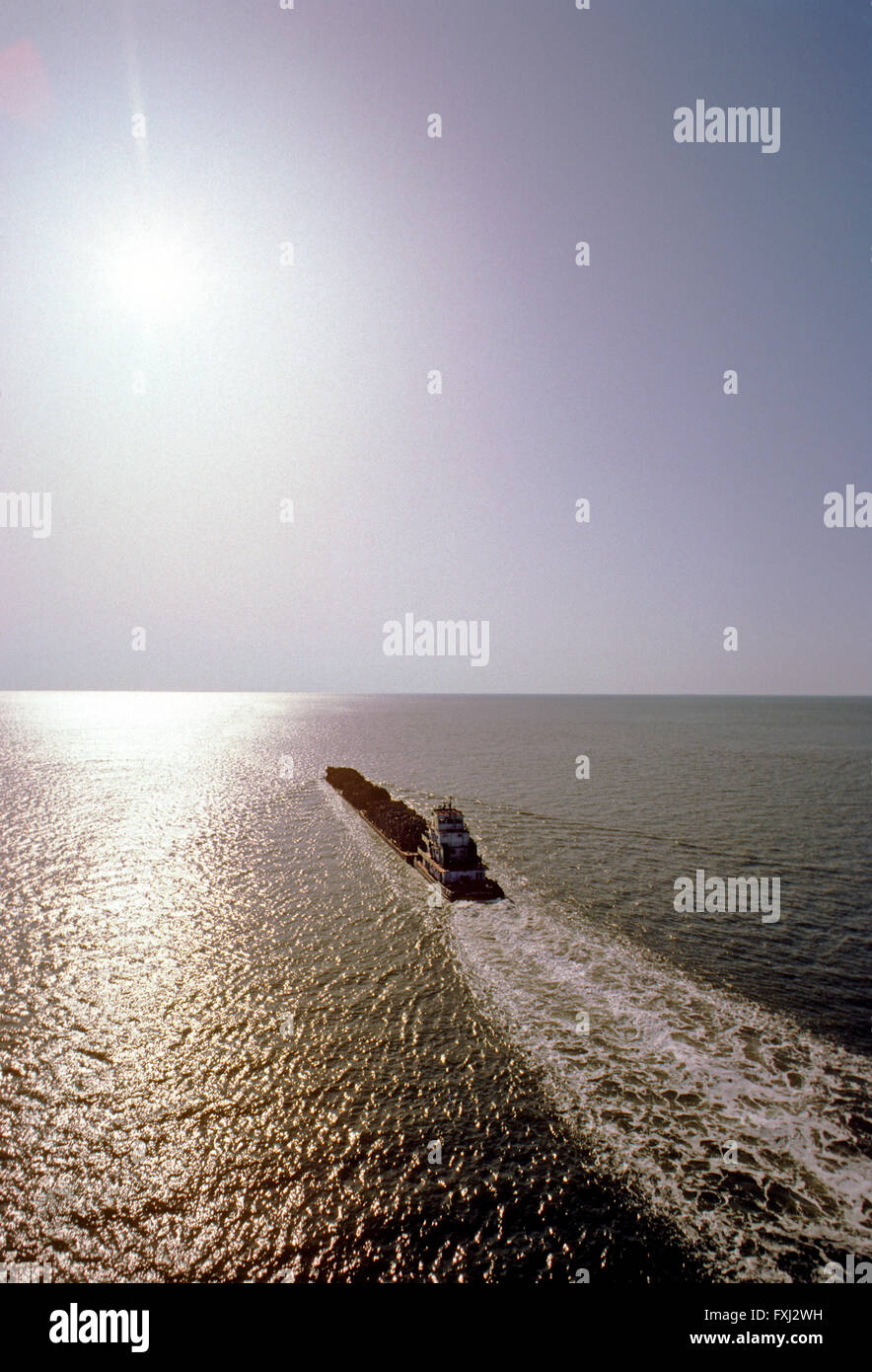 Tug boat pushing barges loaded with logs; Houston Ship Channel; Texas ...