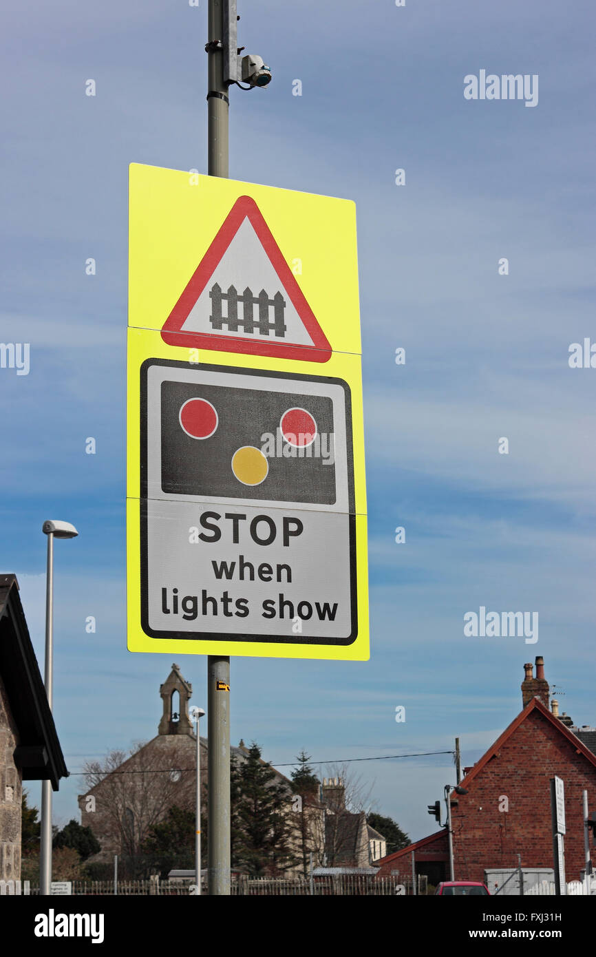 A railway level crossing STOP when lights show sign Stock Photo - Alamy