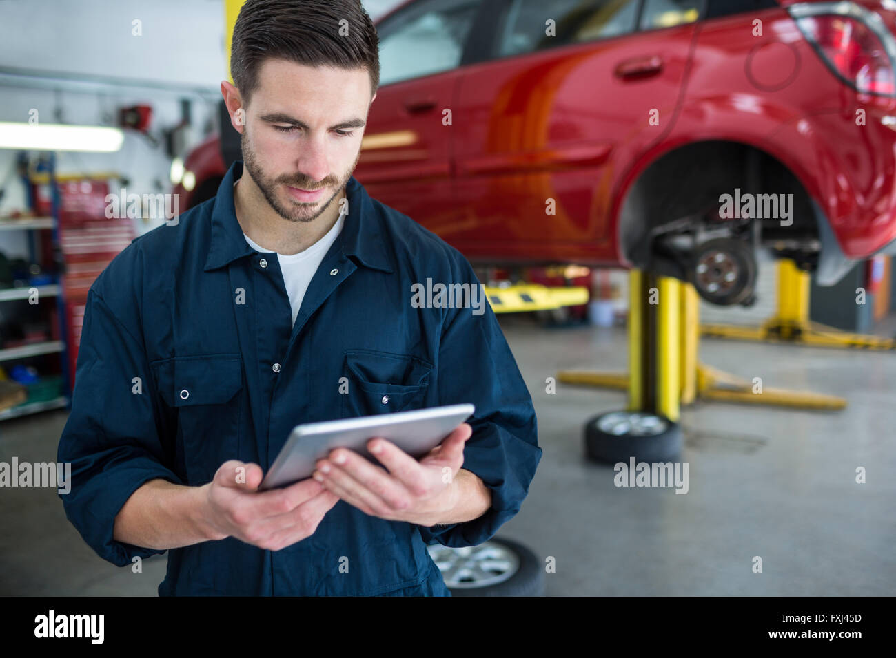 Mechanic using digital tablet Stock Photo - Alamy