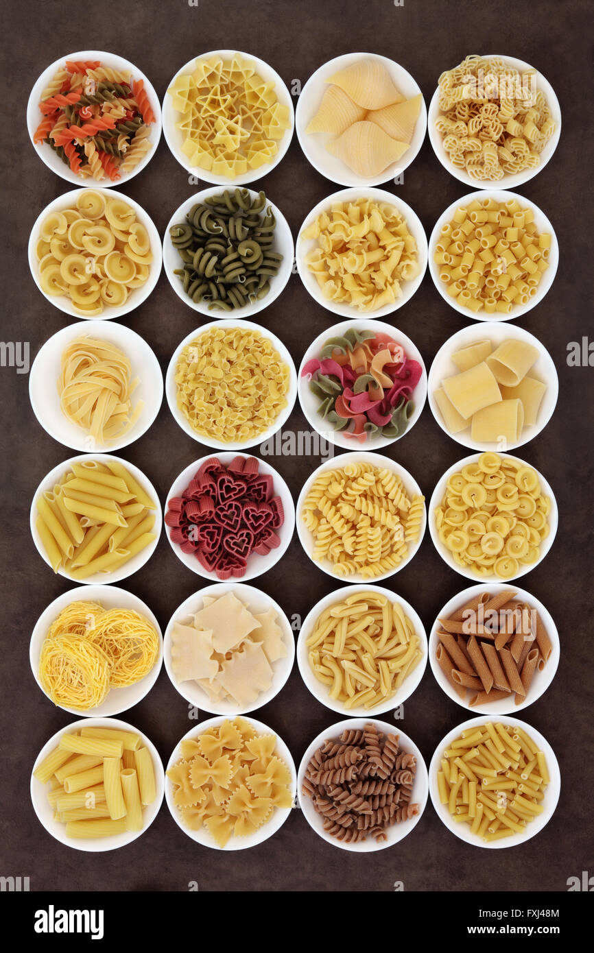 Large italian pasta dried food selection in round bowls over brown ...