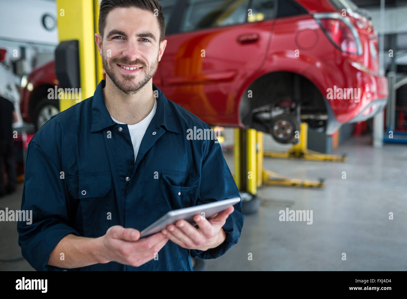 Mechanic holding digital tablet Stock Photo - Alamy