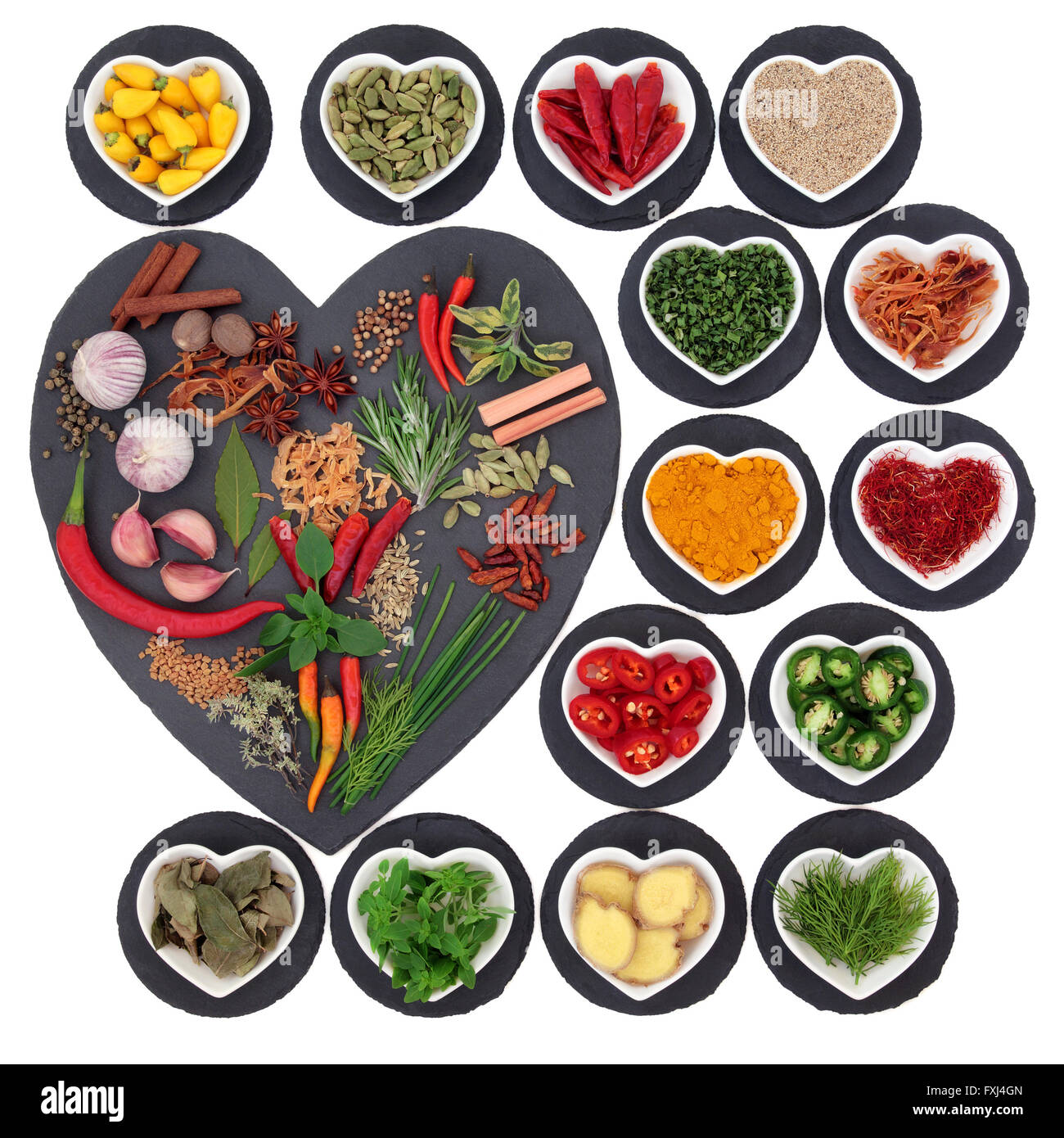 Spice and herb collection on heart shaped slate and rounds and in ...
