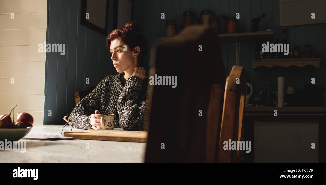 Young woman sitting dining table hi-res stock photography and images ...
