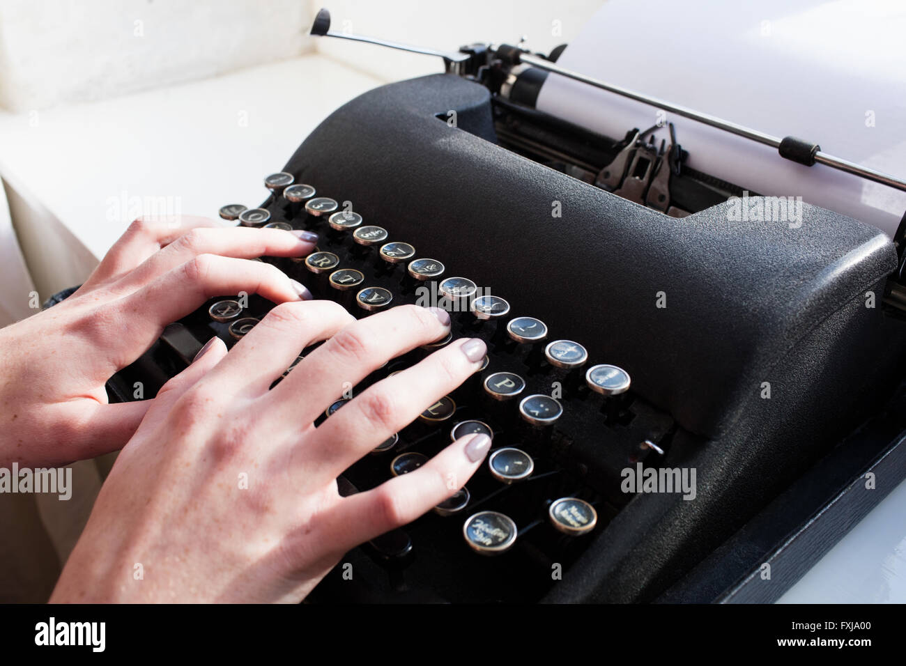 Womans hand typing on typewriter Stock Photo - Alamy
