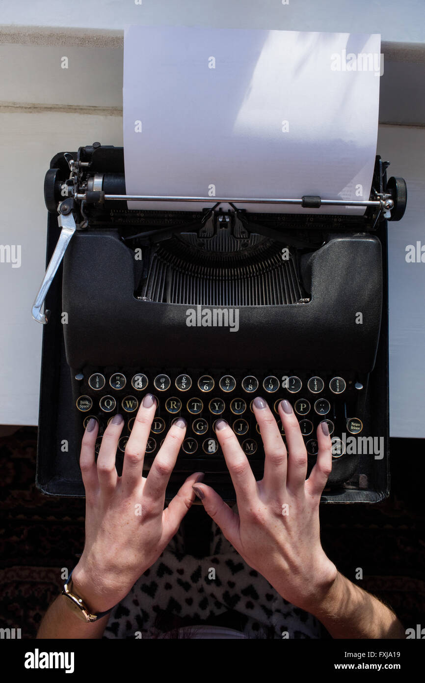 Womans hand typing on typewriter Stock Photo - Alamy