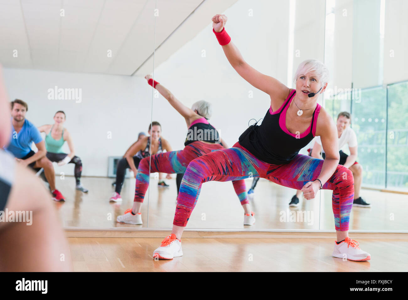 Fitness instructor leading aerobics class Stock Photo - Alamy