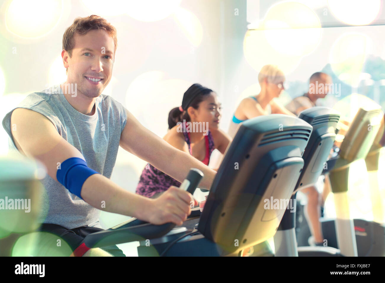 Portrait smiling man riding exercise bike at gym Stock Photo - Alamy