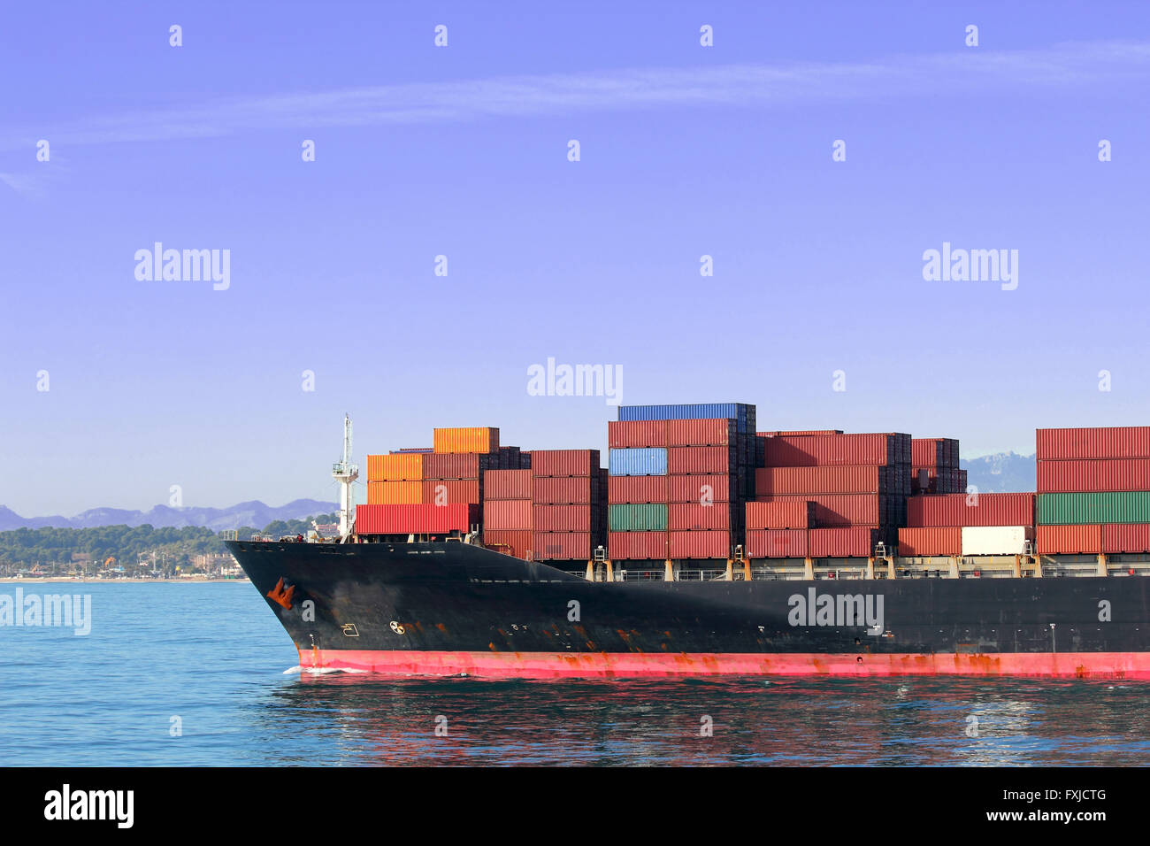 Container ship sailing, against blue sky Stock Photo - Alamy