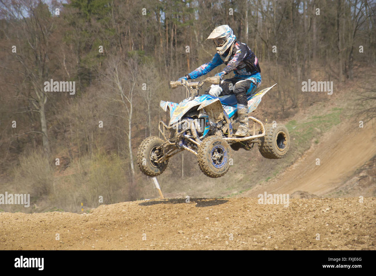 Racer is jumping on quad motorbike Stock Photo - Alamy