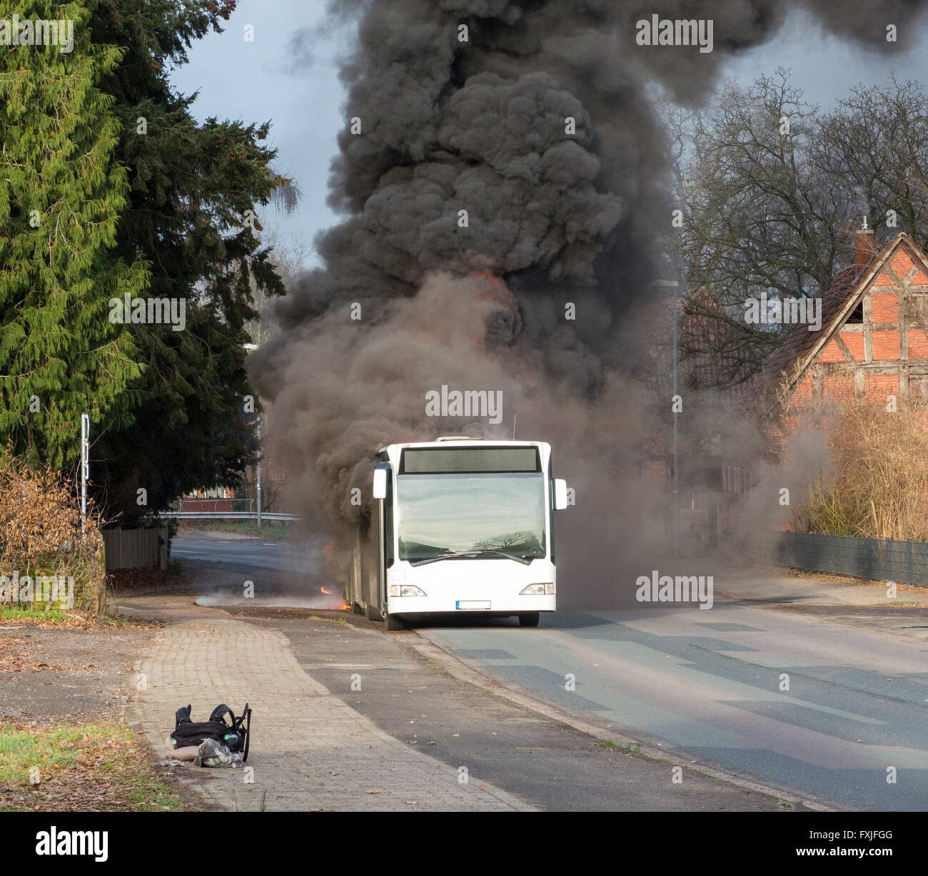 Burning school bus on a road in Sebbenhausen, community Balge Stock ...