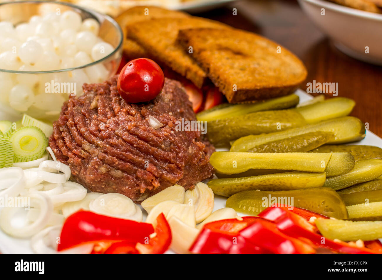 Raw beef Steak tartare with onion and toast Stock Photo - Alamy