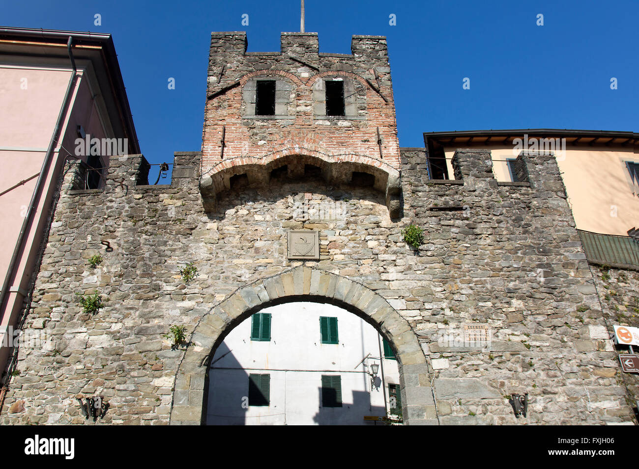 Entrance gate of the medieval town Barga in Lucca province, Tuscany ...