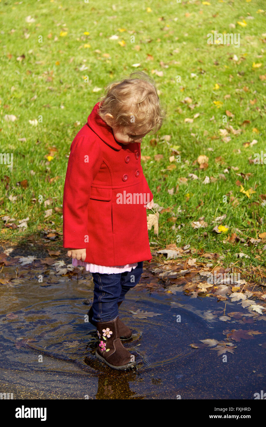 Child playing in puddle Stock Photo - Alamy