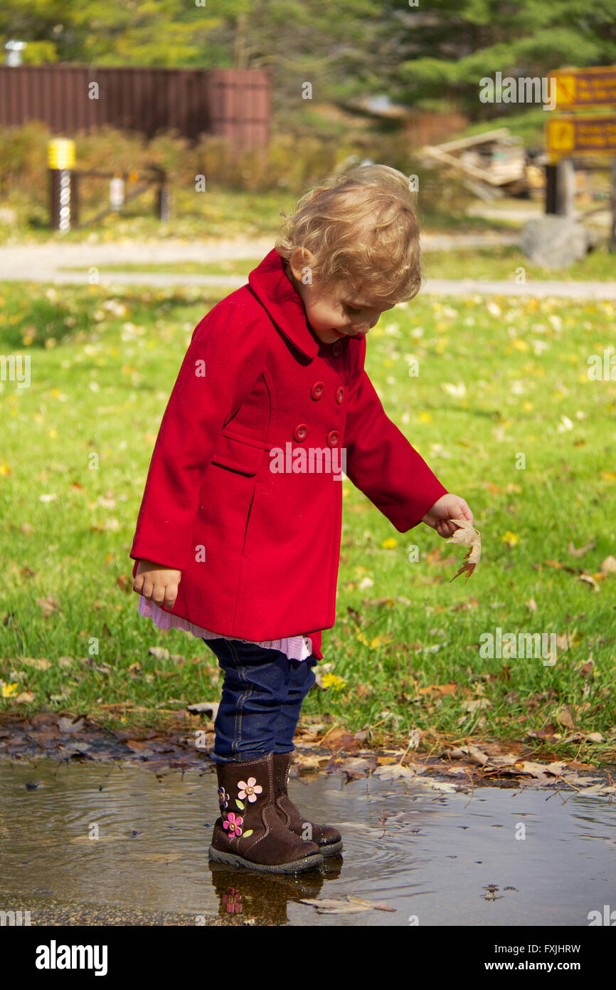 Child playing in puddle Stock Photo - Alamy