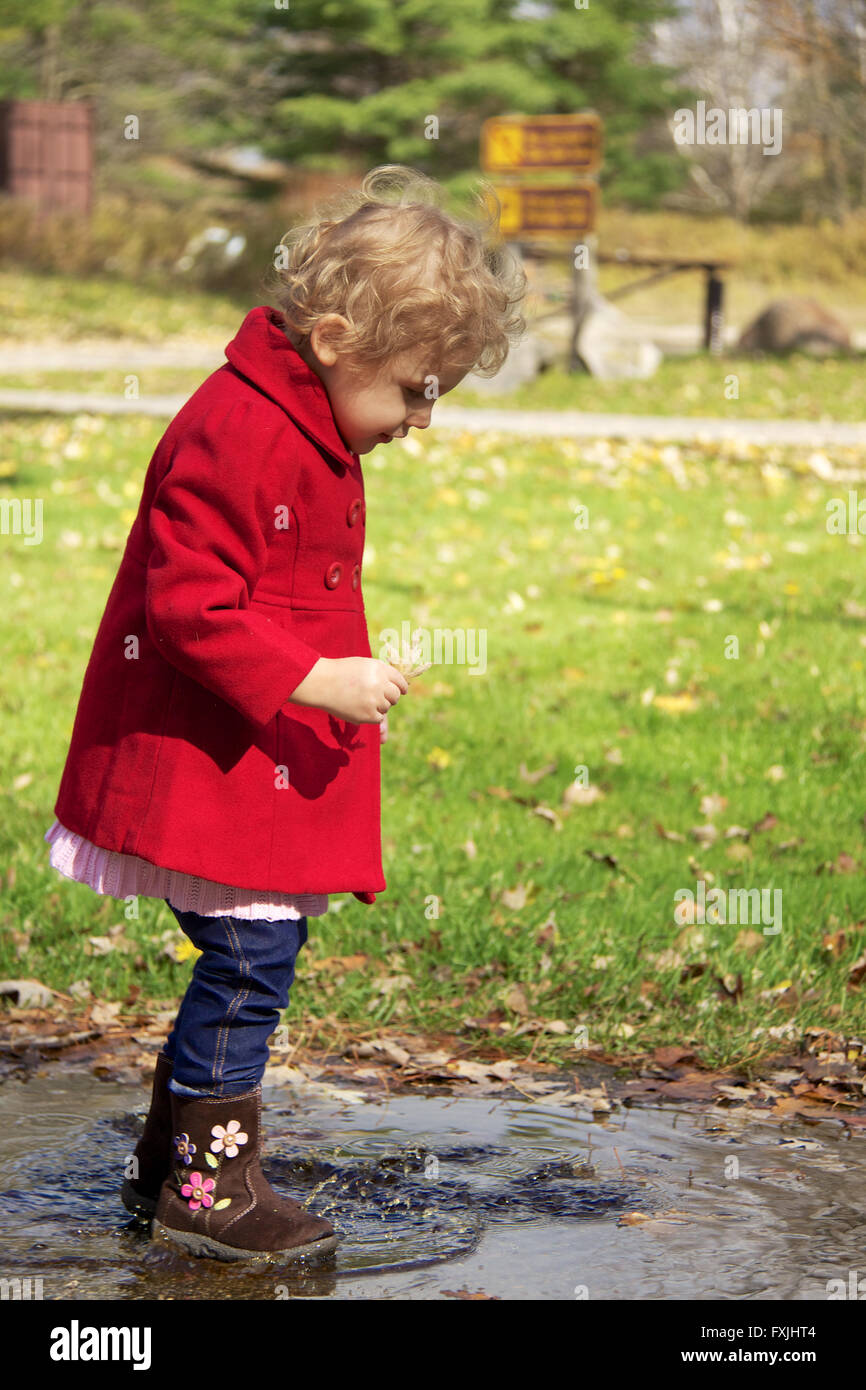 Child playing in puddle Stock Photo - Alamy