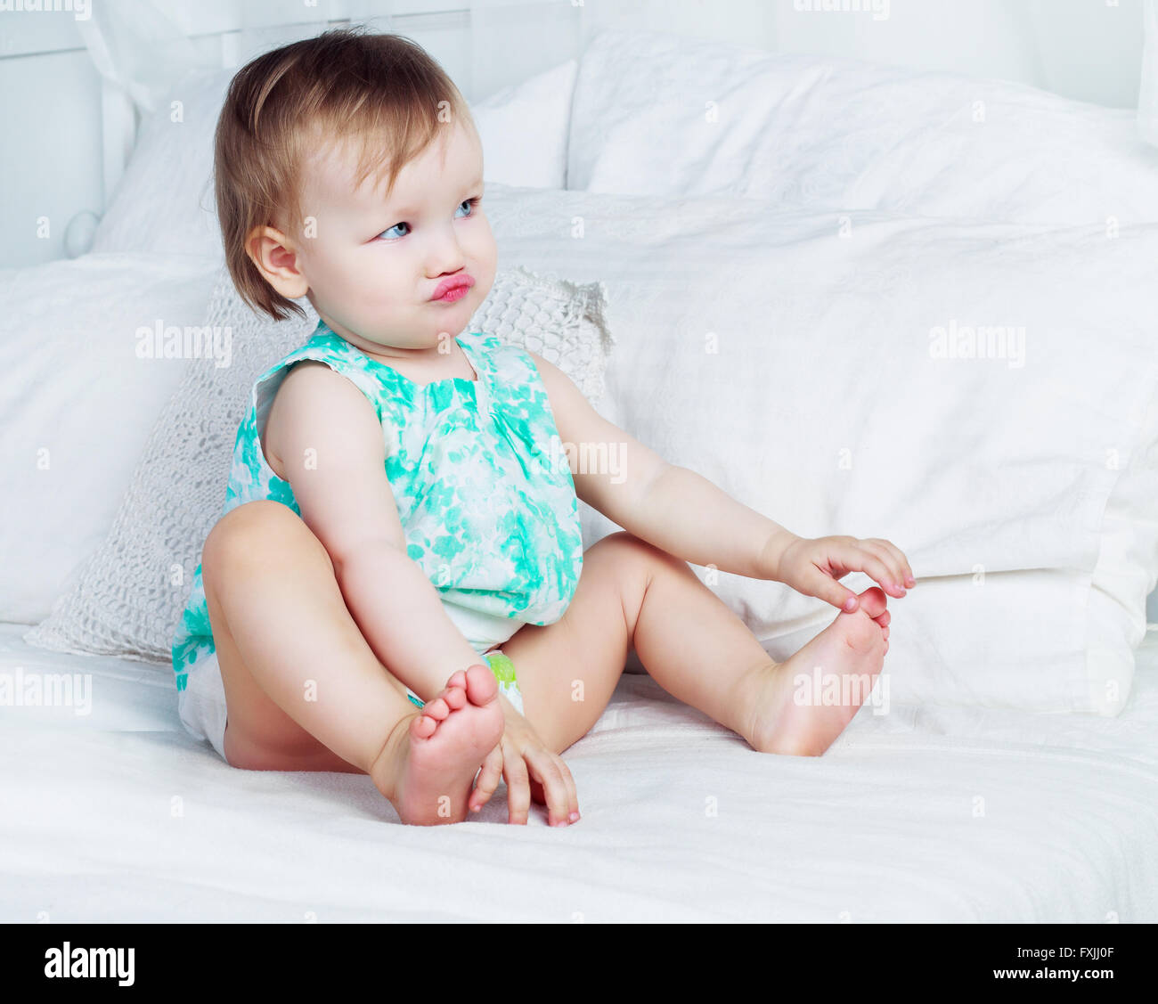 upset-one-year-old-baby-in-bed-at-home-stock-photo-alamy