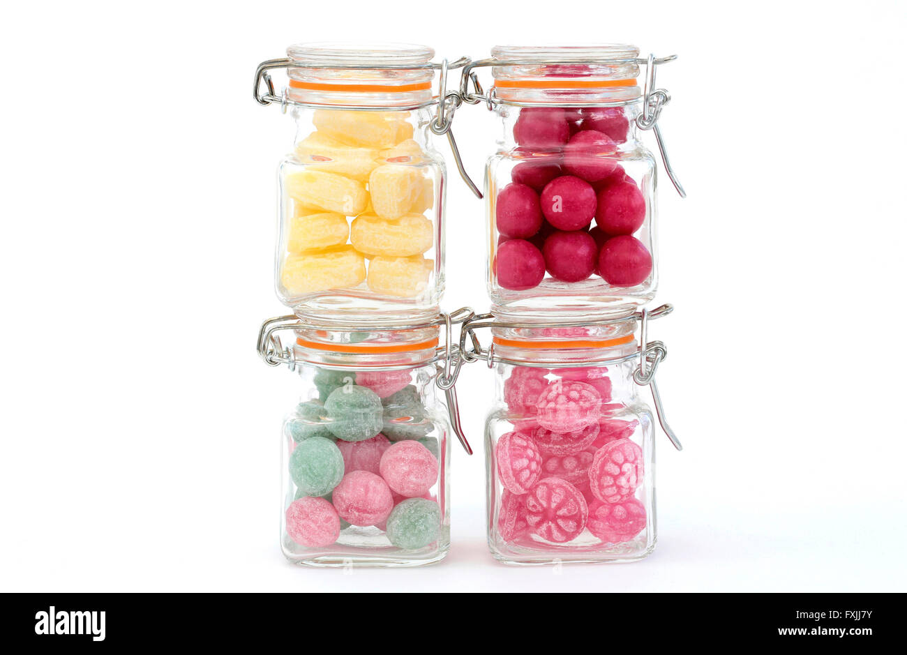 Four jars filled with colorful candy Stock Photo - Alamy
