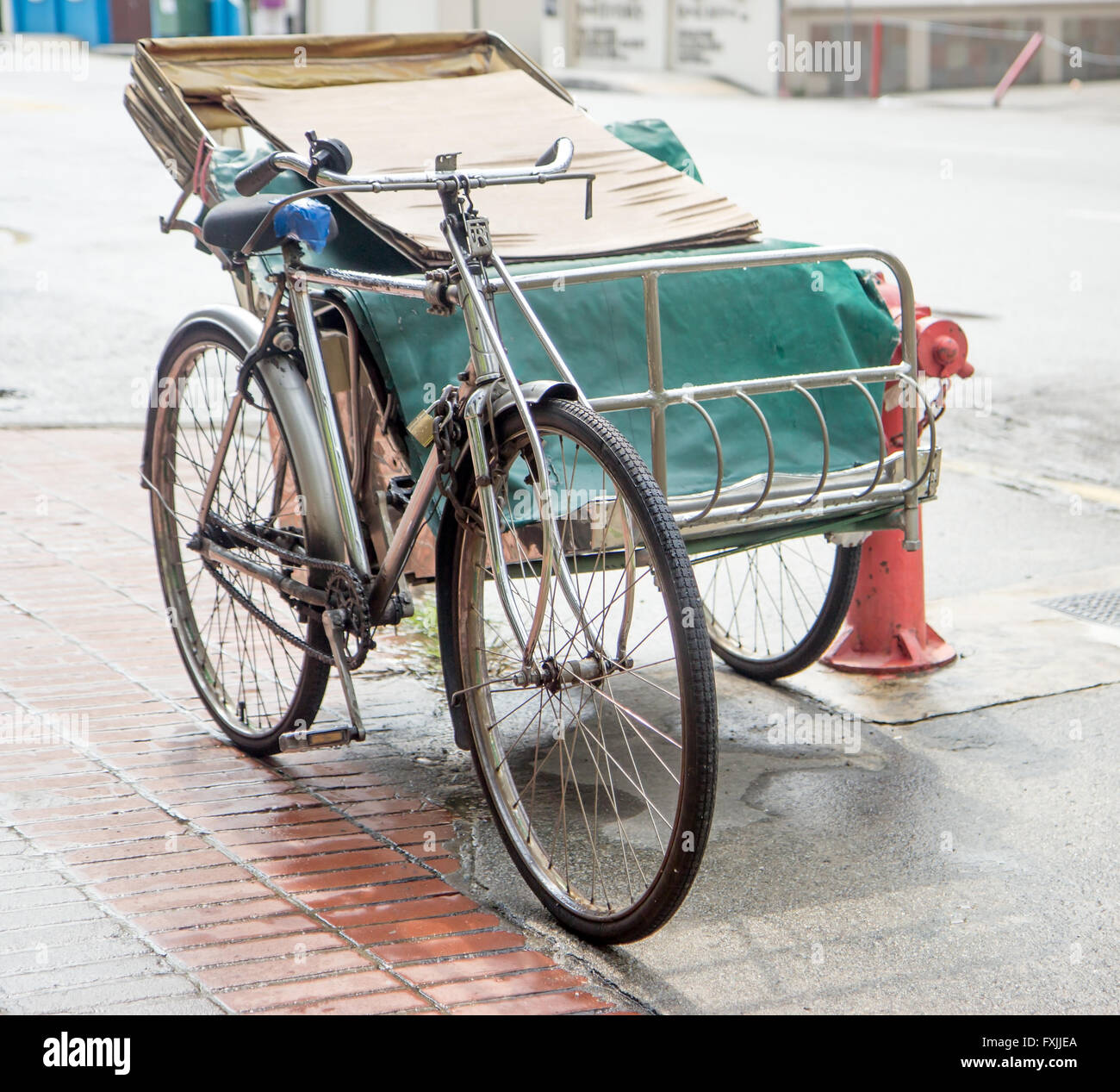 tricycle on the street in Singapore Stock Photo - Alamy
