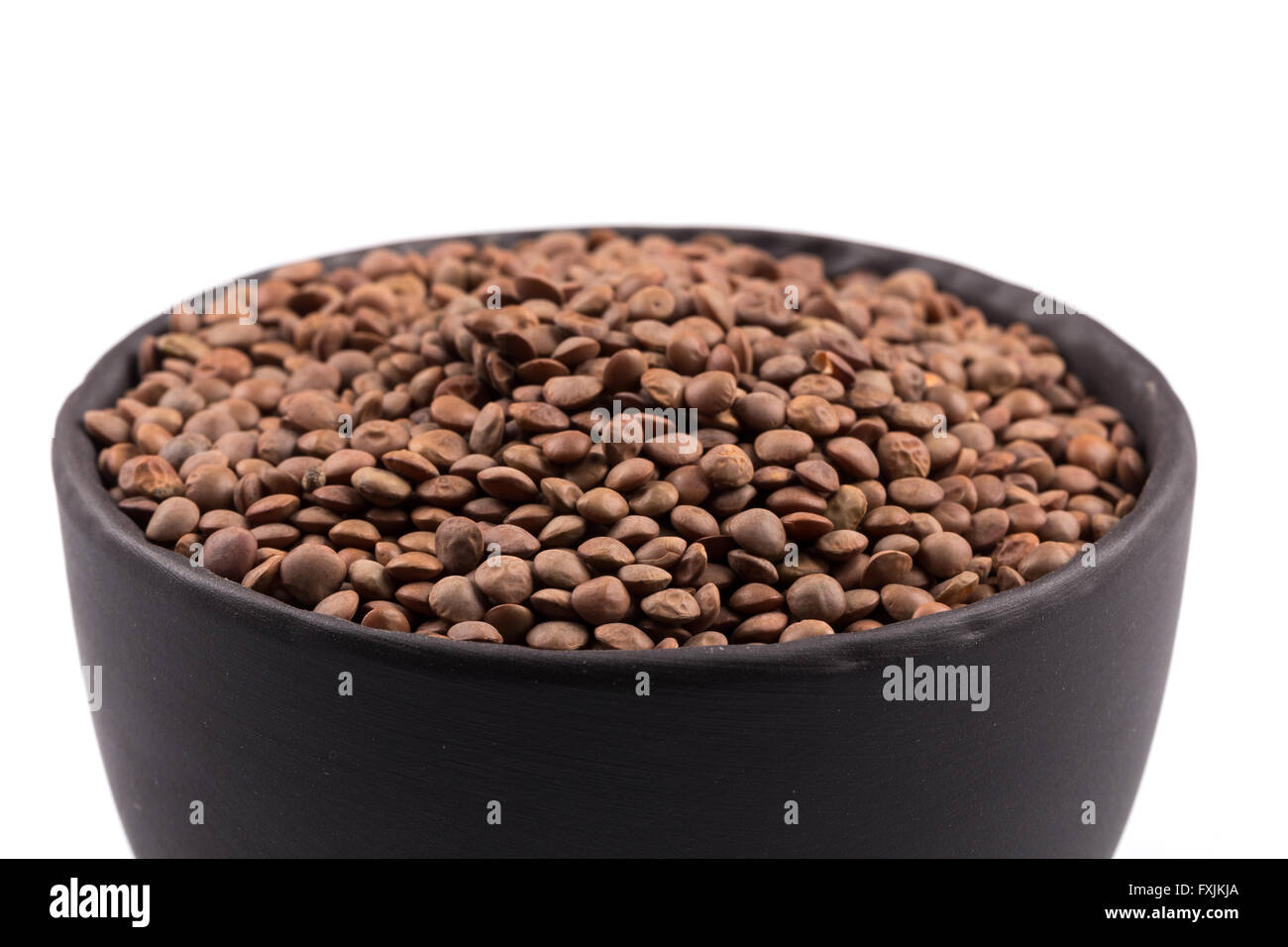Organic lentils in bowl Isolated on a white background - close up shot ...