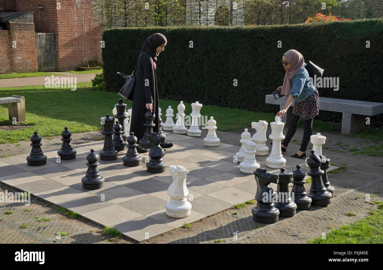 Muslim women playing big set of chess outdoors in Holland Park. London ...