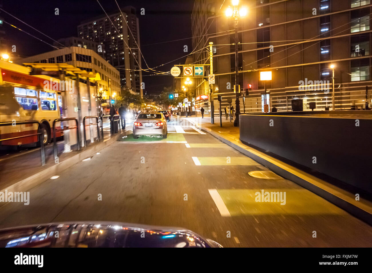 Market Street in San Francisco at night with the bike lane marked in ...