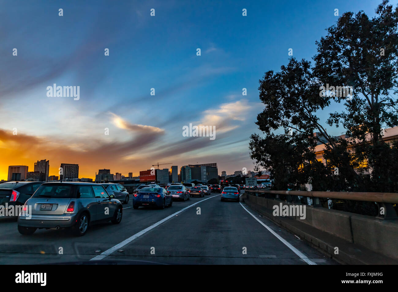 Highway 101 in San Francisco with the City skyline and a sunset in the ...